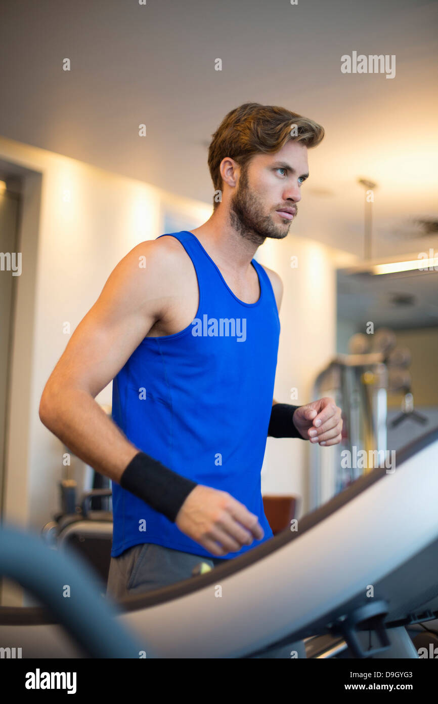 Man running on a treadmill in a gym Stock Photo - Alamy