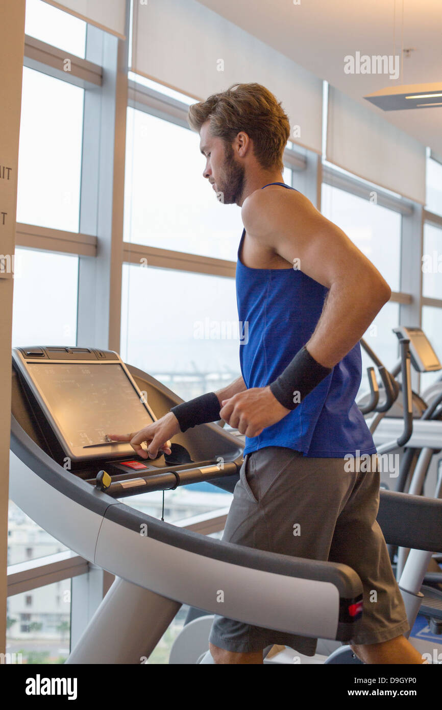Man running on a treadmill in a gym Stock Photo - Alamy
