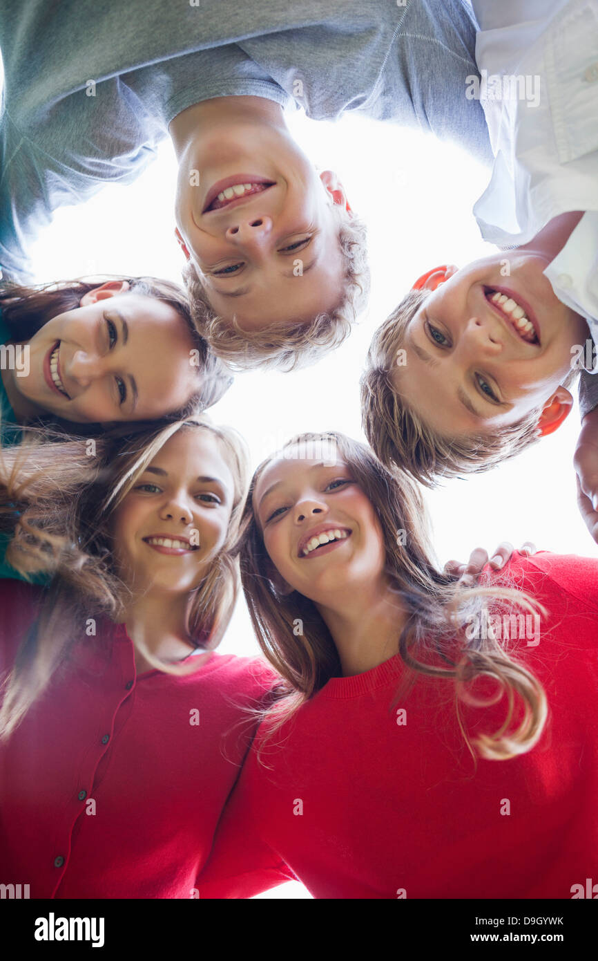 Low angle view of friends in a huddle Stock Photo - Alamy