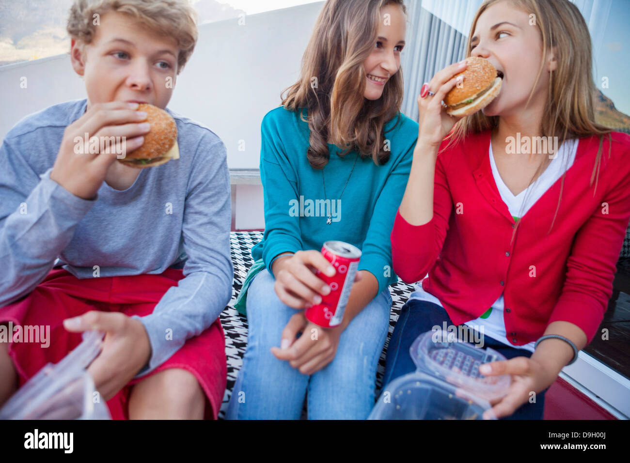 Friends enjoying fast food together Stock Photo - Alamy