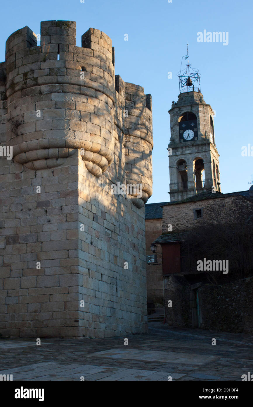 Image of part of old castle in Spain, with church tower in the back ...