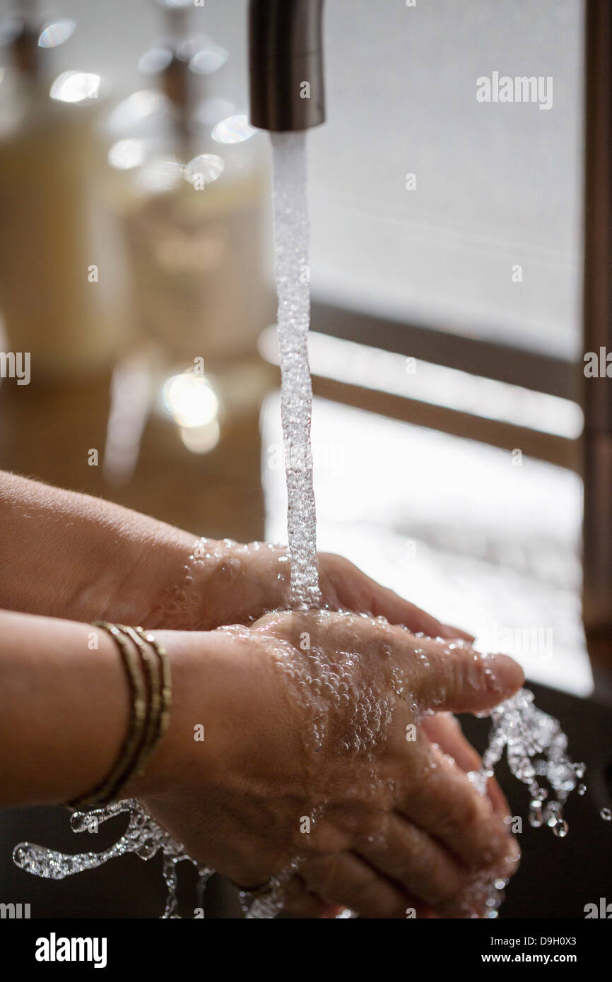 Person washing hands in bathroom sink Stock Photo - Alamy