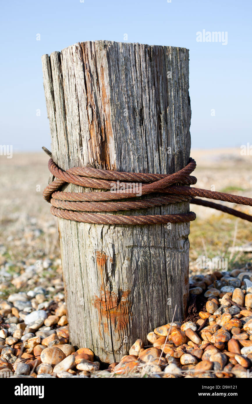 Old rusty cable wrapped around a wooden post Stock Photo - Alamy
