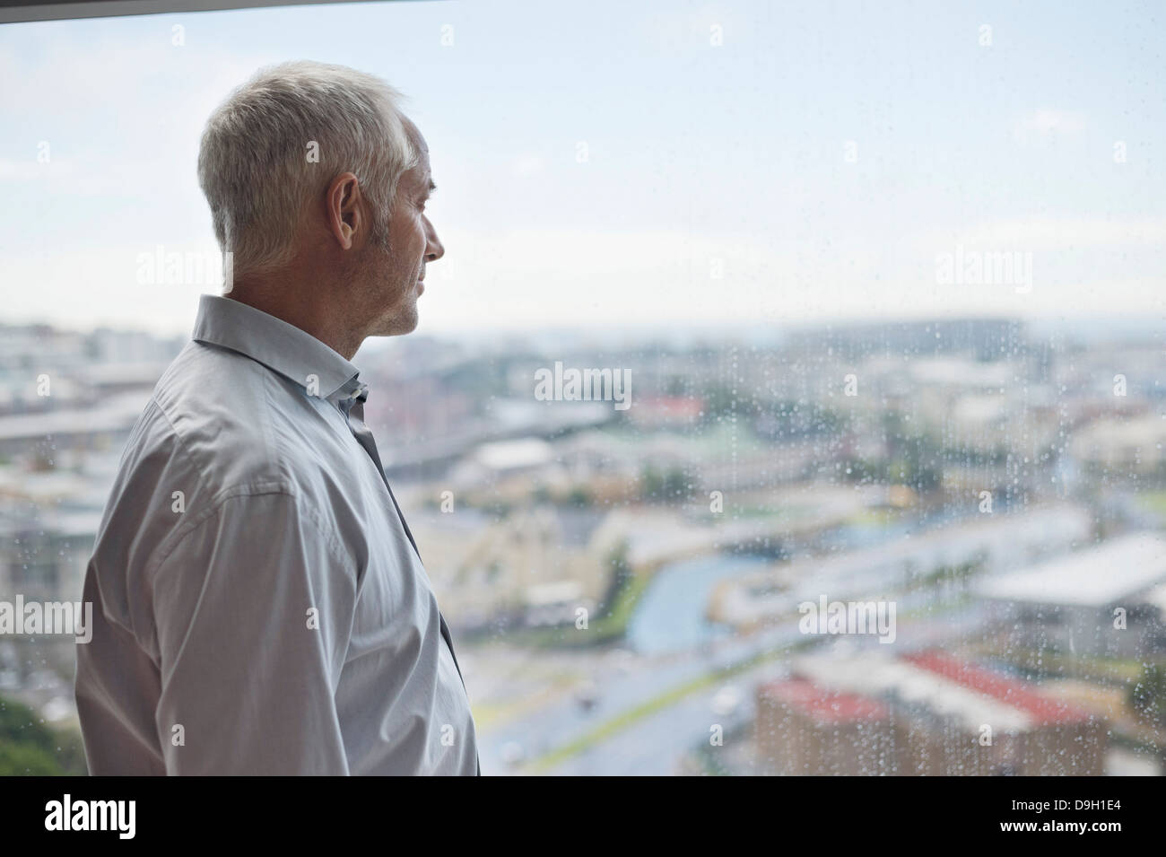 Man looking through a window Stock Photo - Alamy