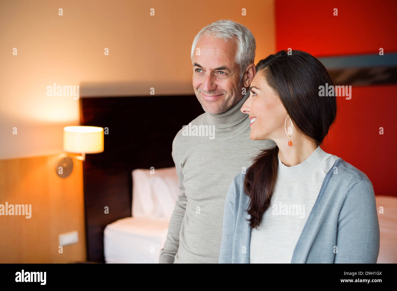 Couple smiling in a hotel room Stock Photo - Alamy