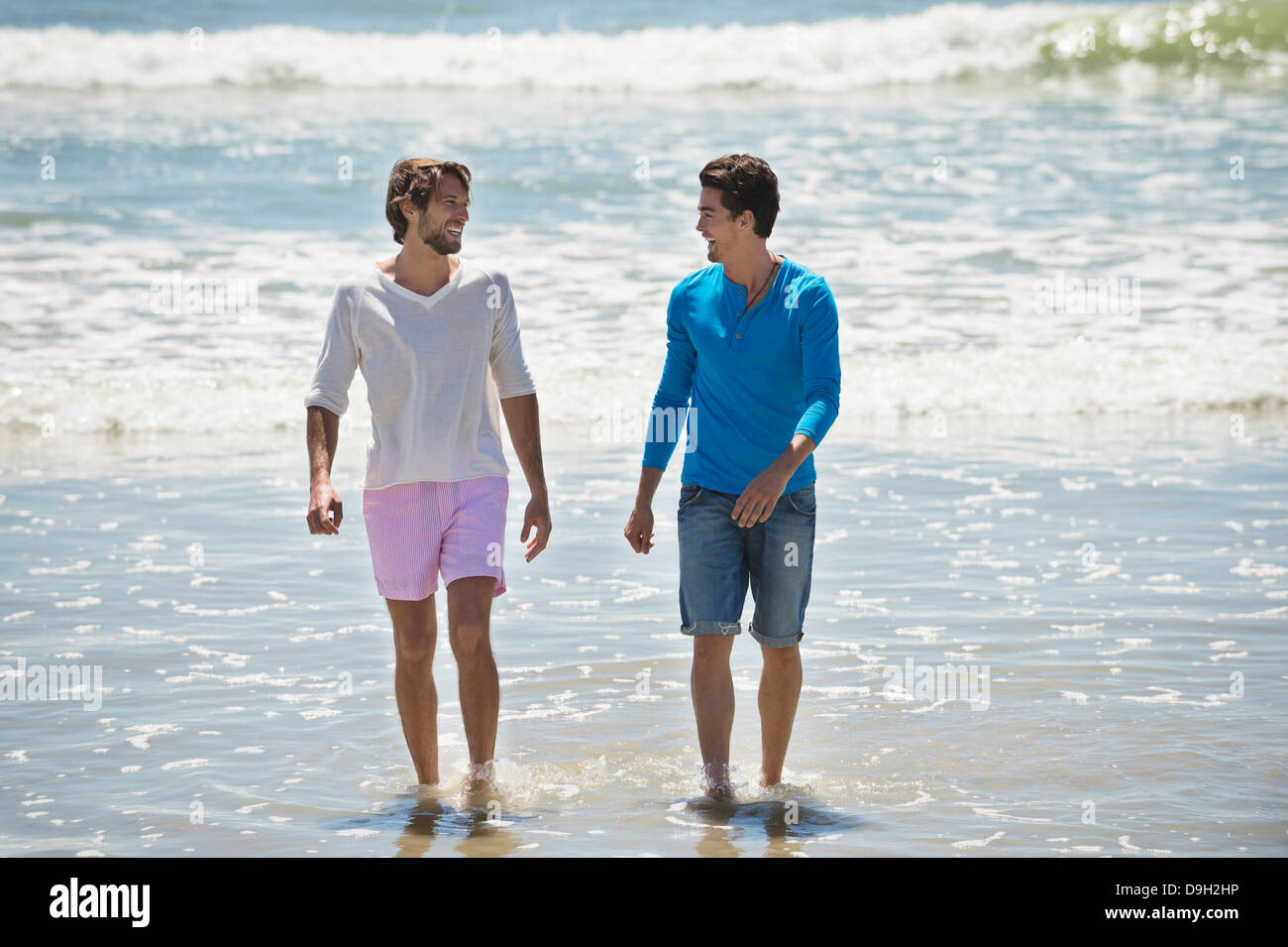Two men enjoying on the beach Stock Photo - Alamy
