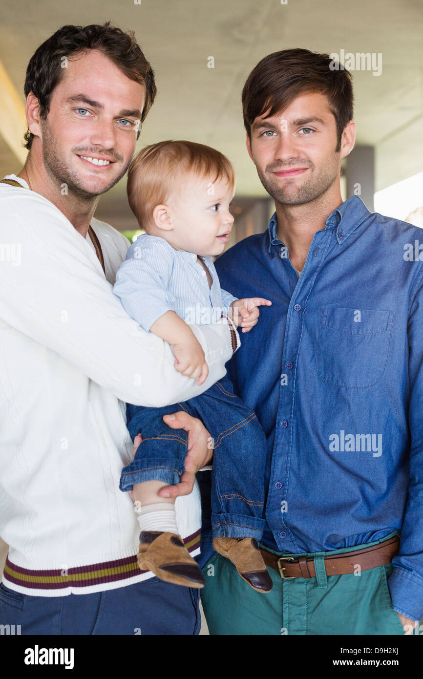 Parents smiling with their son at home Stock Photo - Alamy