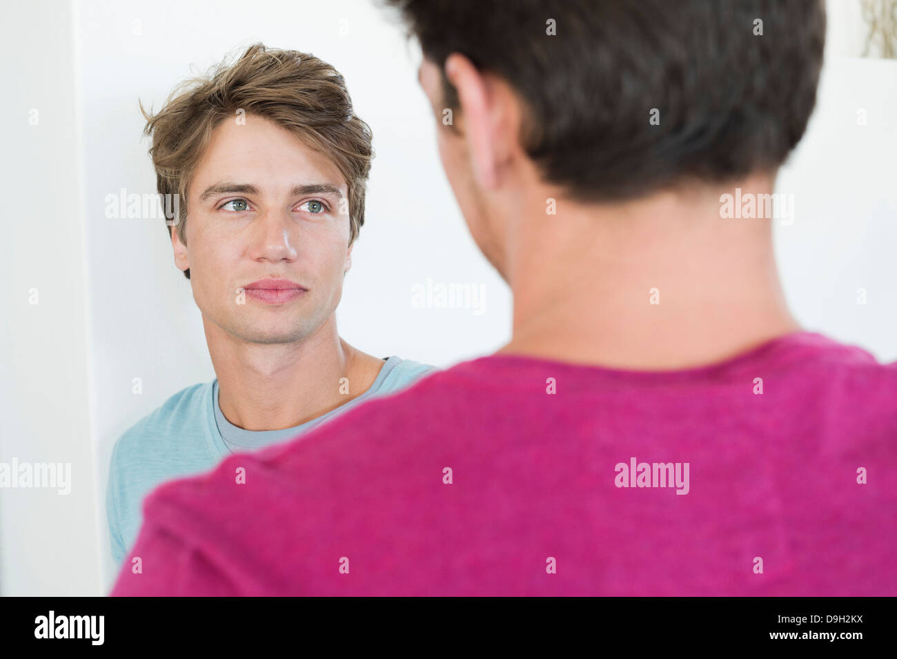 Two male friends talking to each other Stock Photo - Alamy
