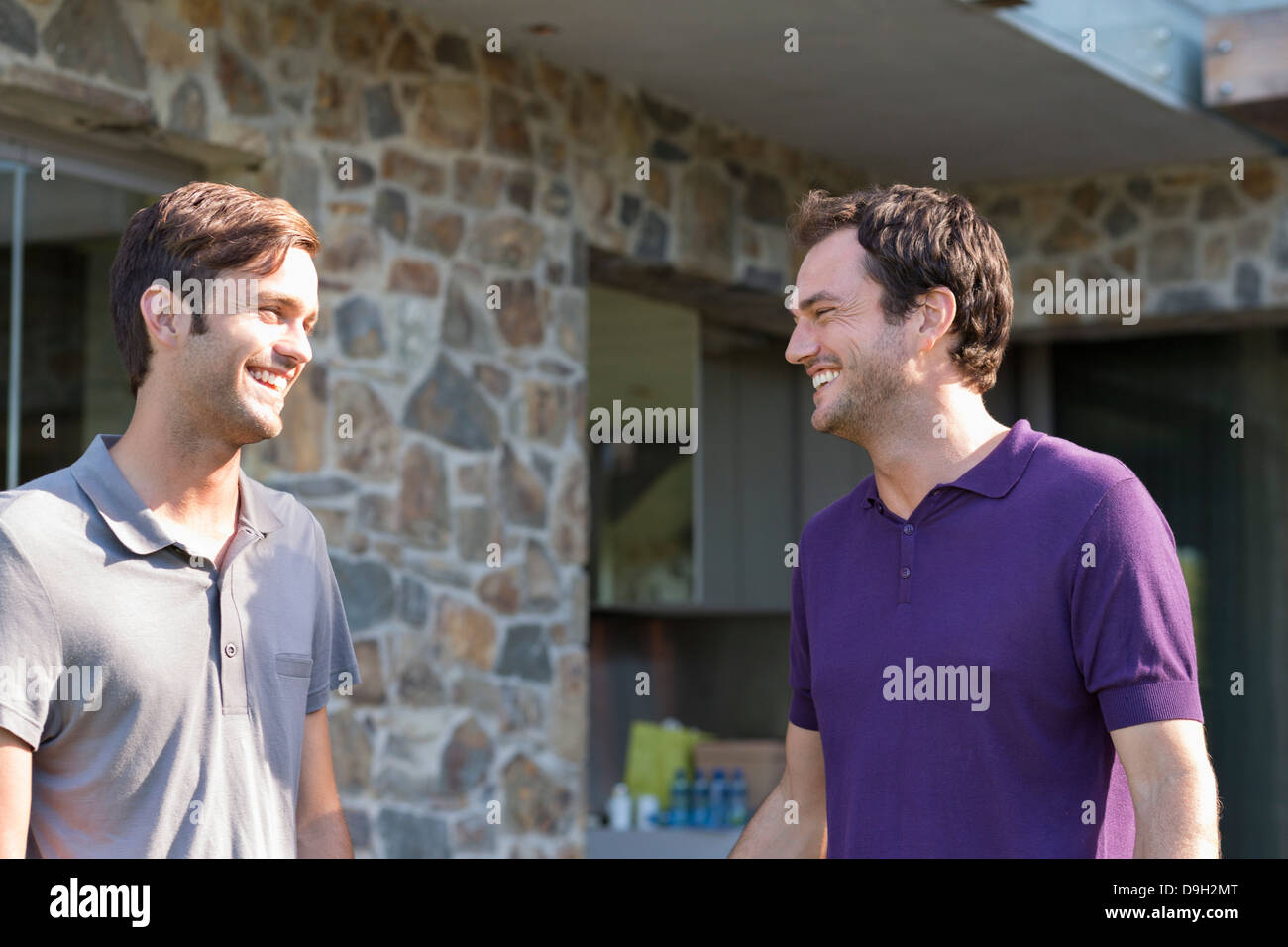 Two male friends smiling Stock Photo - Alamy