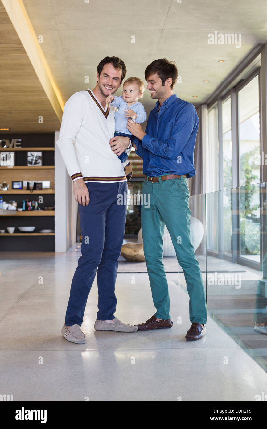 Parents smiling with their son at home Stock Photo - Alamy