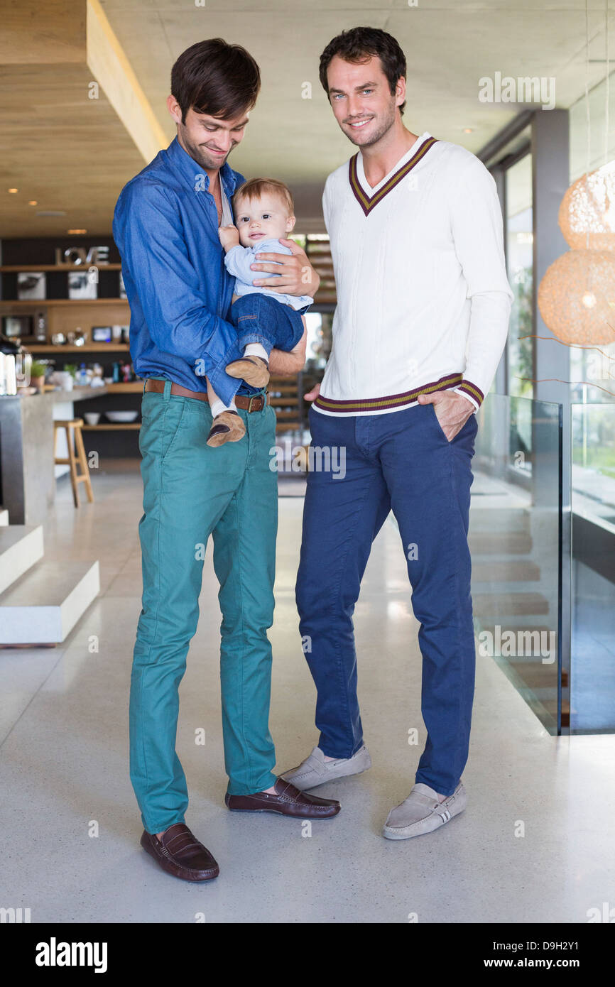 Parents smiling with their son at home Stock Photo - Alamy