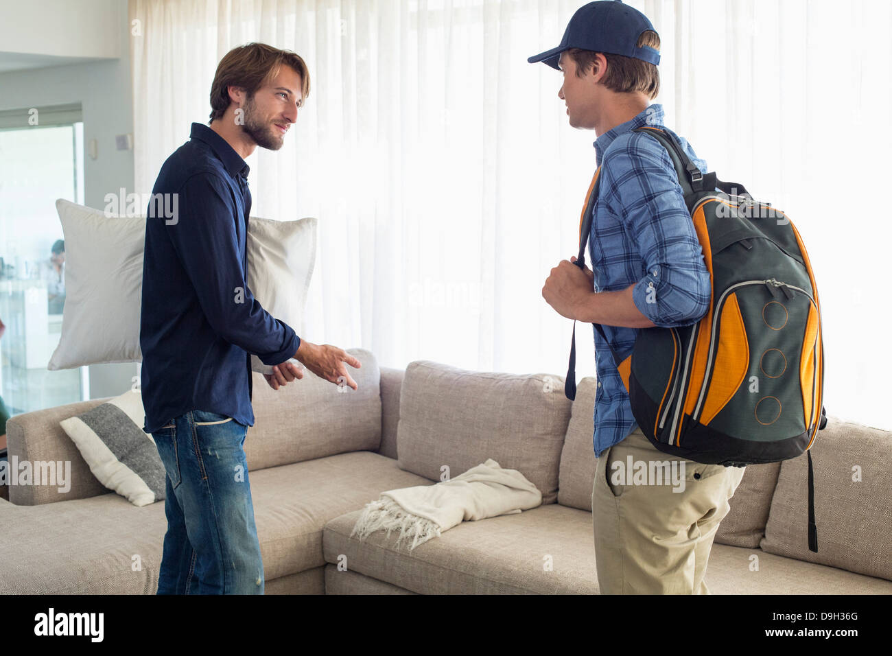 Man offering seat to his friend Stock Photo - Alamy
