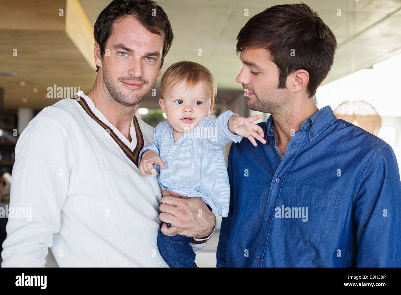 Parents smiling with their son at home Stock Photo - Alamy