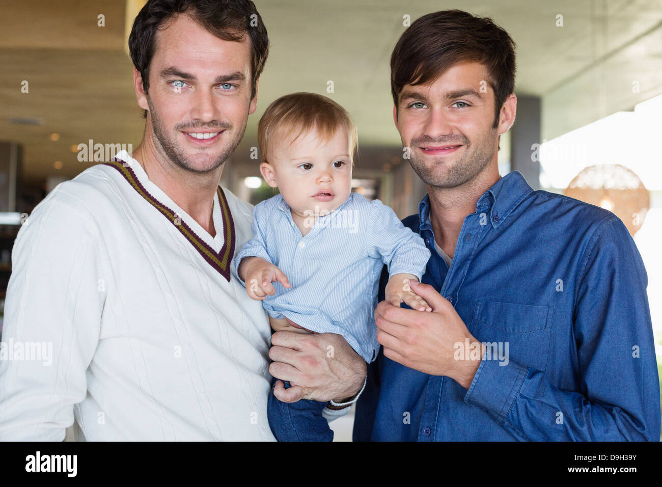 Parents smiling with their son at home Stock Photo - Alamy