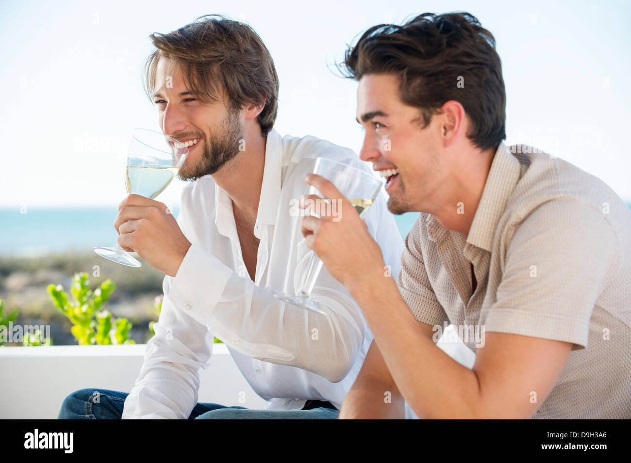 Three cheerful friends man two hi-res stock photography and images - Alamy