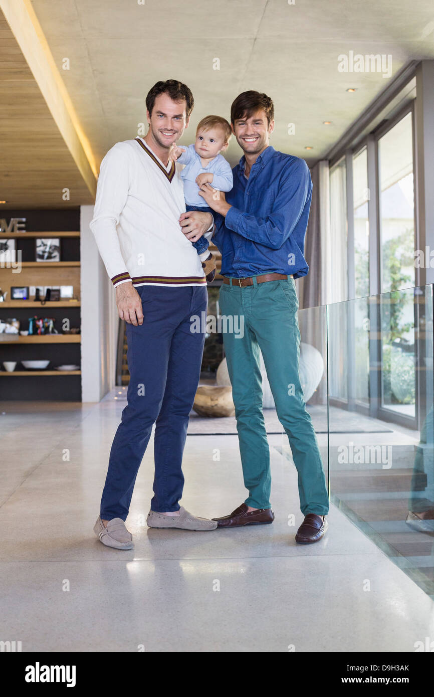 Parents smiling with their son at home Stock Photo - Alamy