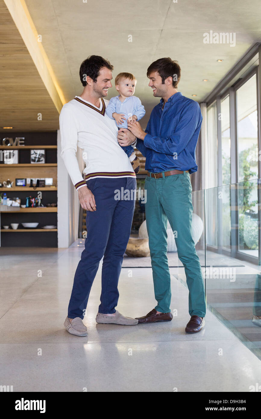 Parents smiling with their son at home Stock Photo - Alamy