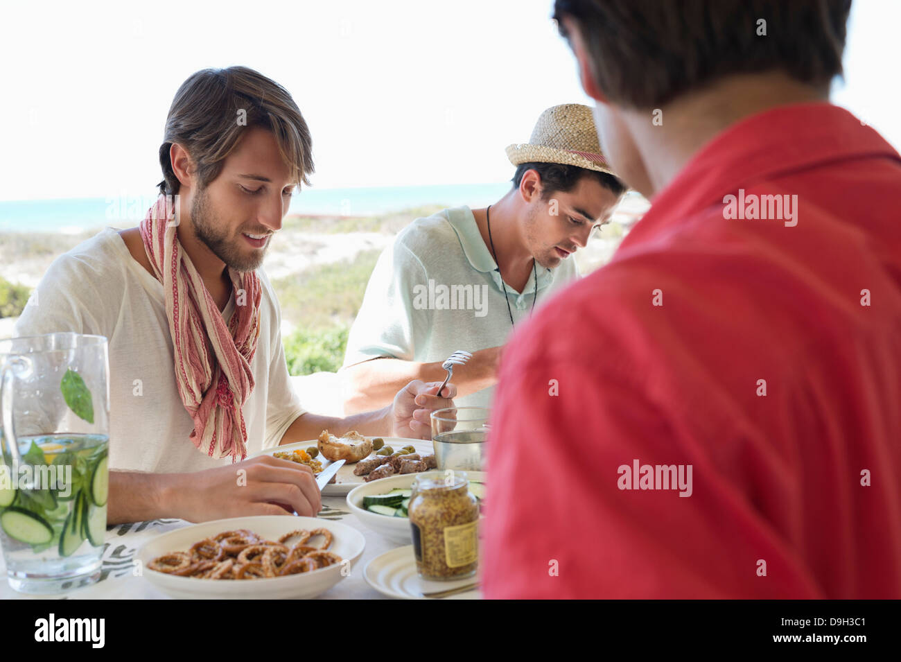 Friends eating lunch at dining table Stock Photo - Alamy