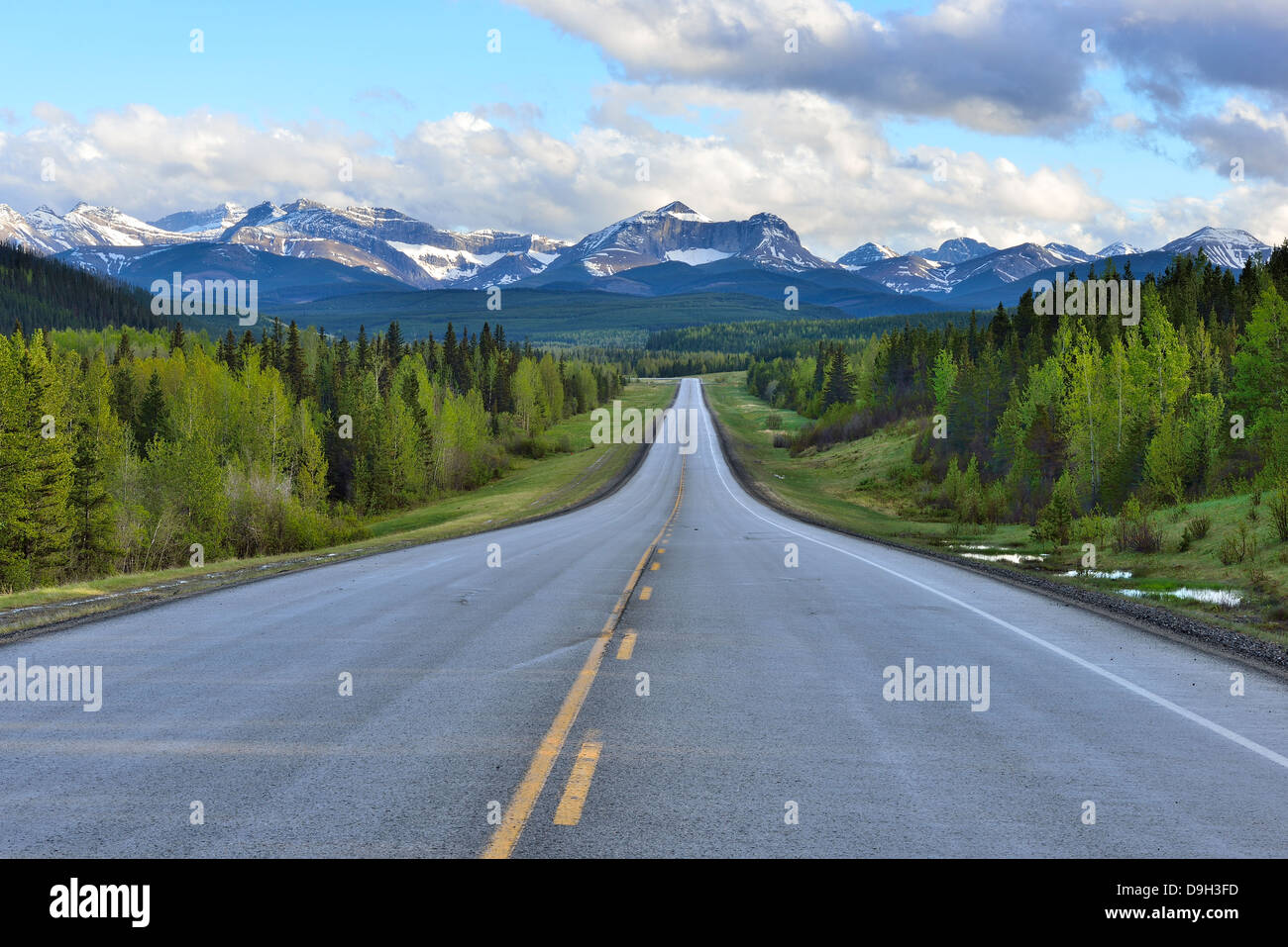 A straight stretch of a two lane black top highway heading toward the ...