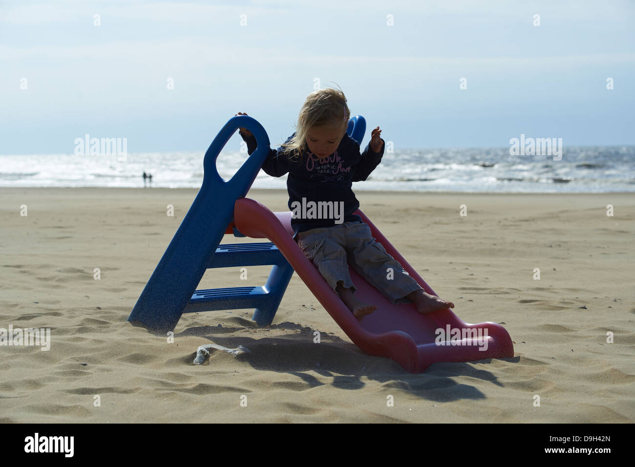 Girl playing slide hi-res stock photography and images - Alamy