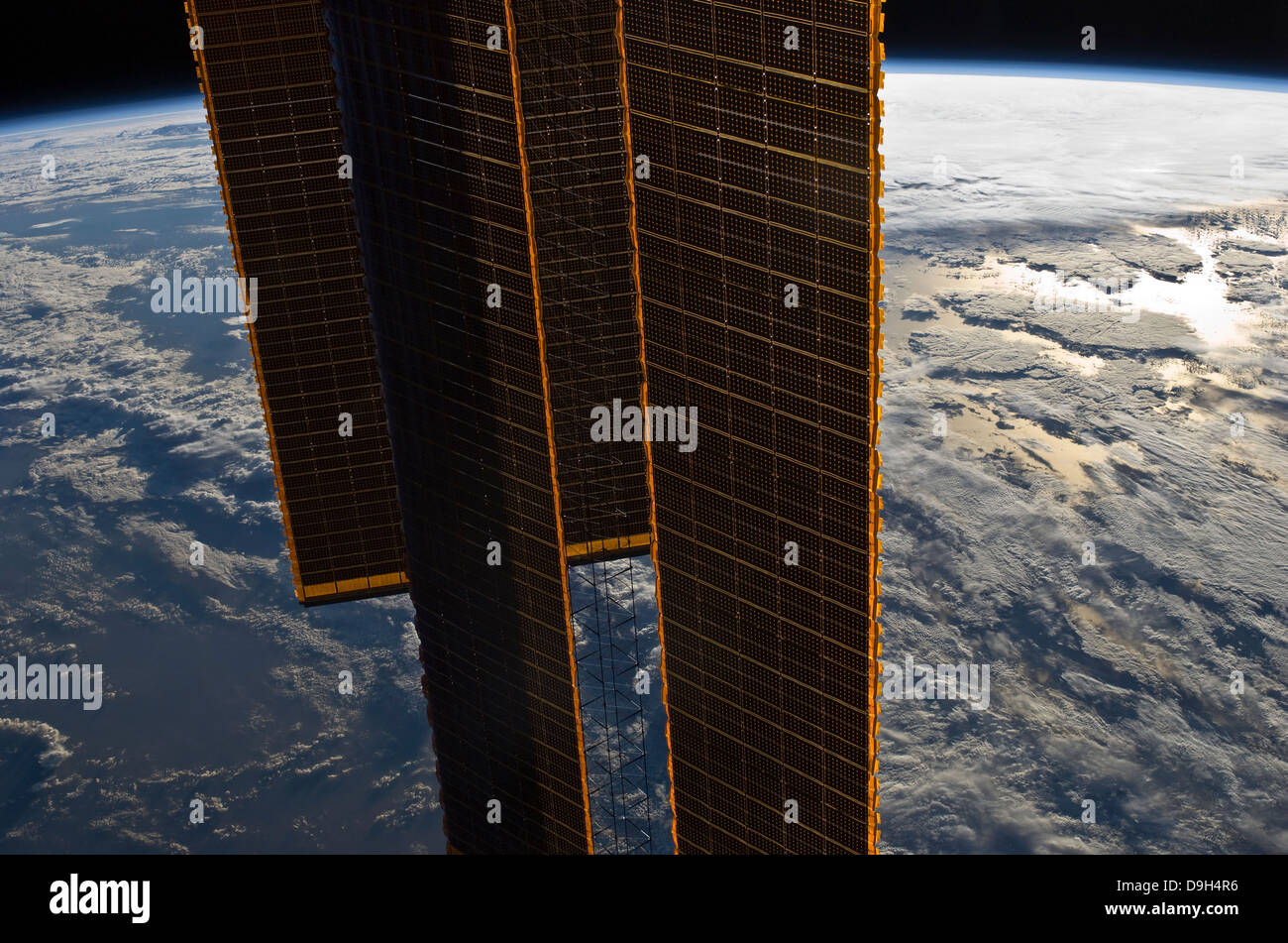 Solar panels of the International Space Station backdropped by a blue ...