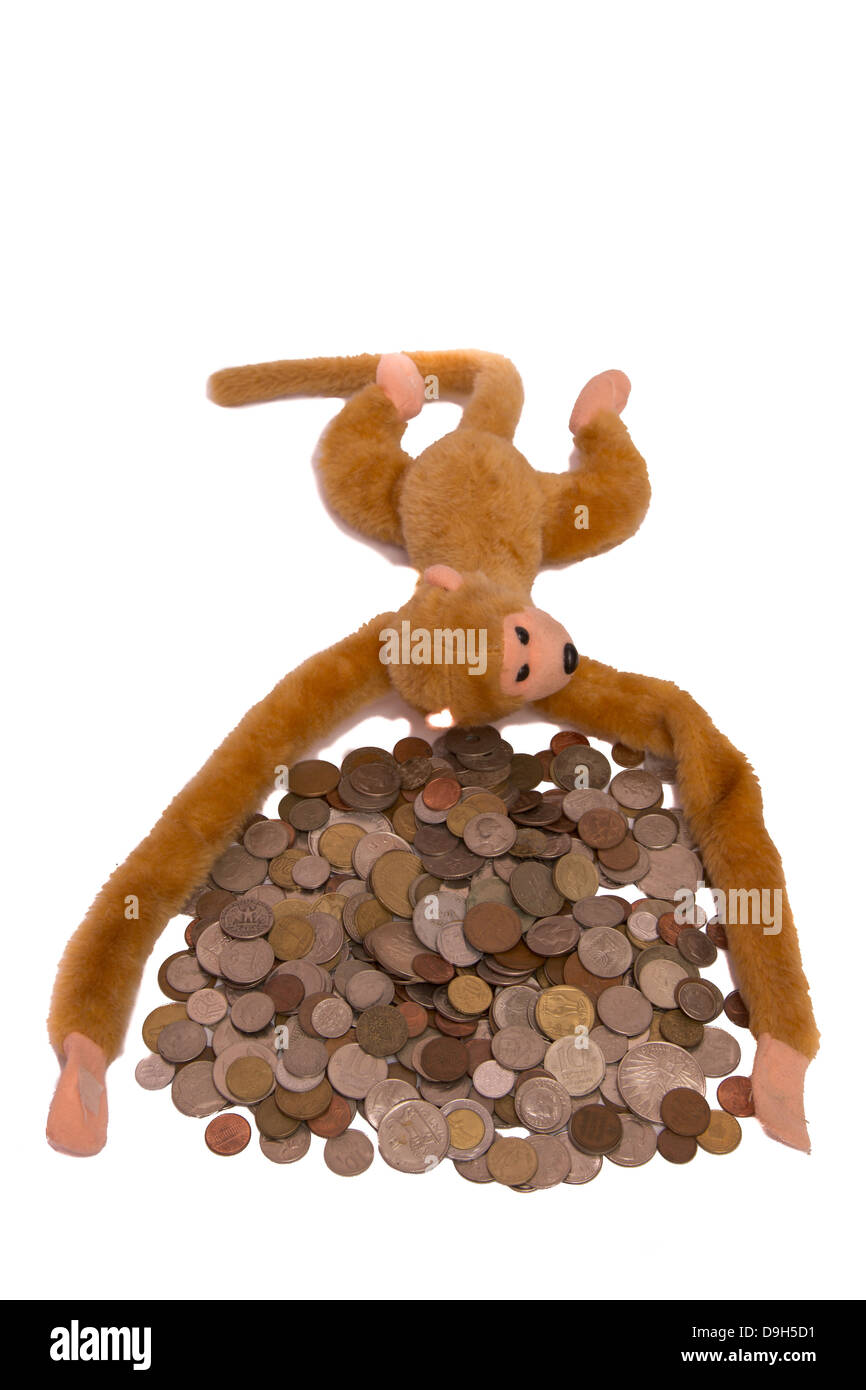 Pile of coins and a monkey isolated on white background Stock Photo - Alamy