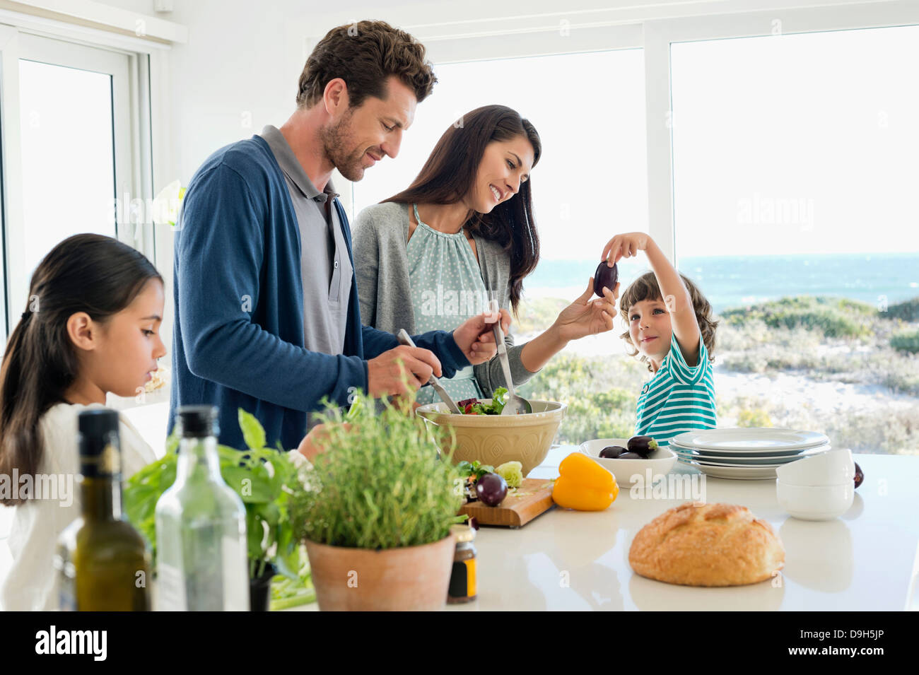 Family preparing food in the kitchen Stock Photo - Alamy