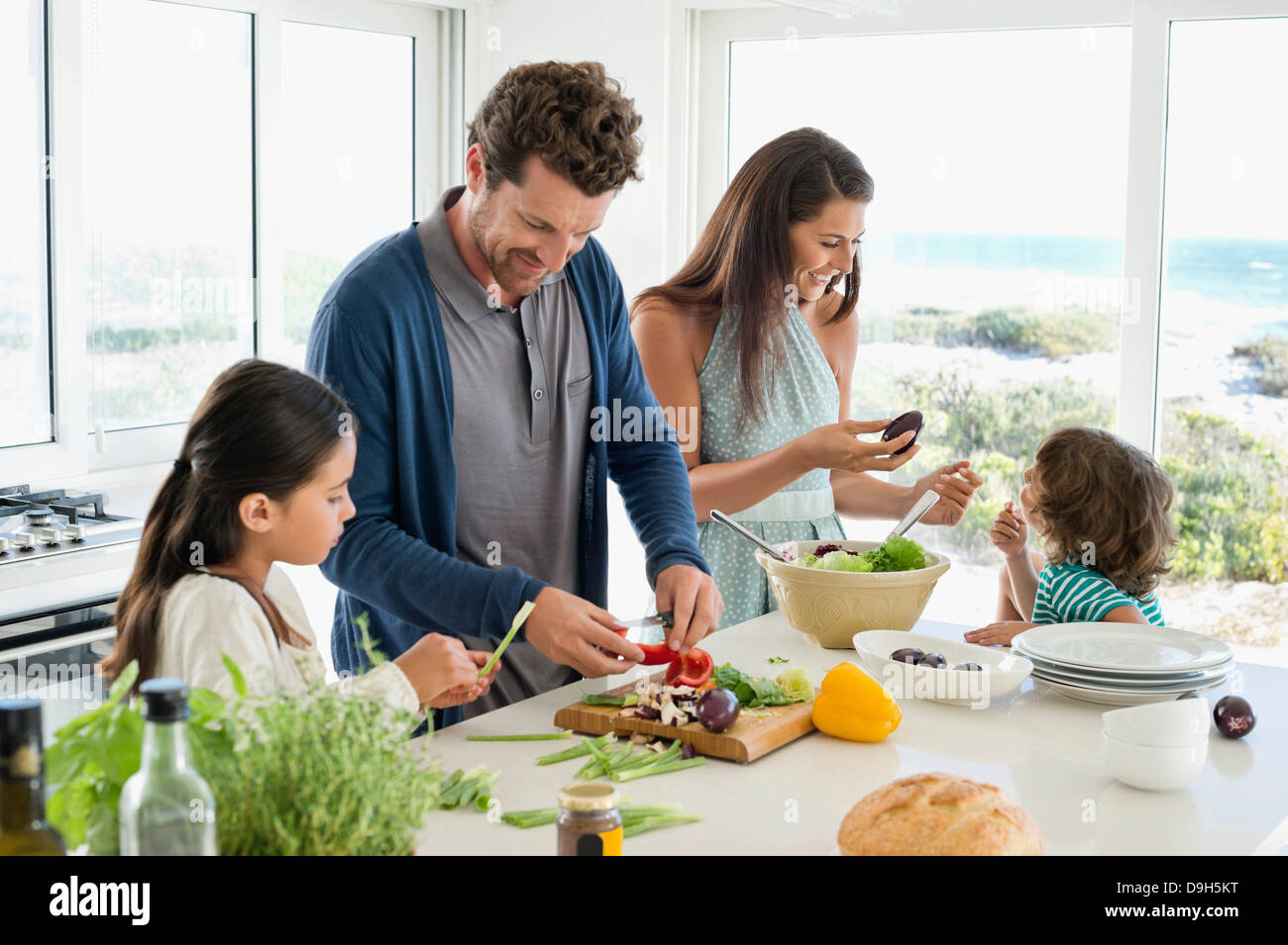 Family preparing food in the kitchen Stock Photo - Alamy