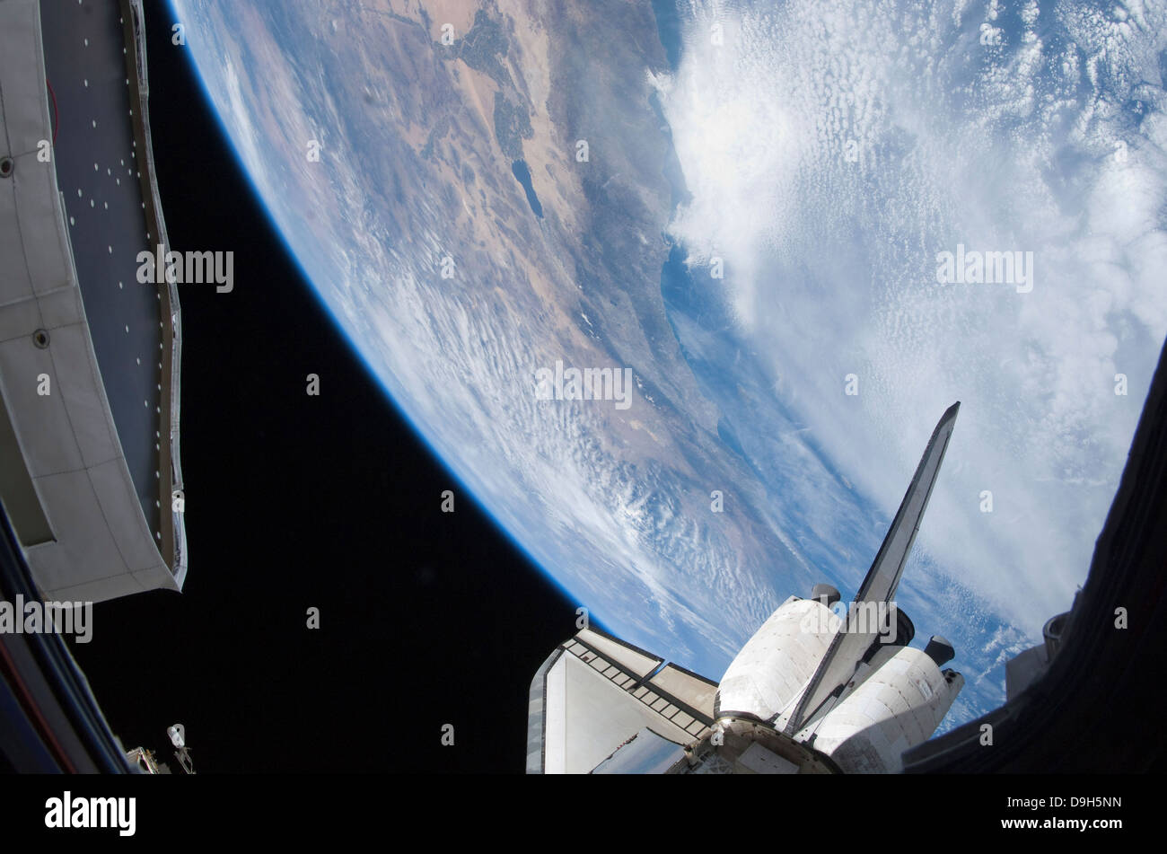 Part of space shuttle Discovery backdropped against the Pacific Coast ...