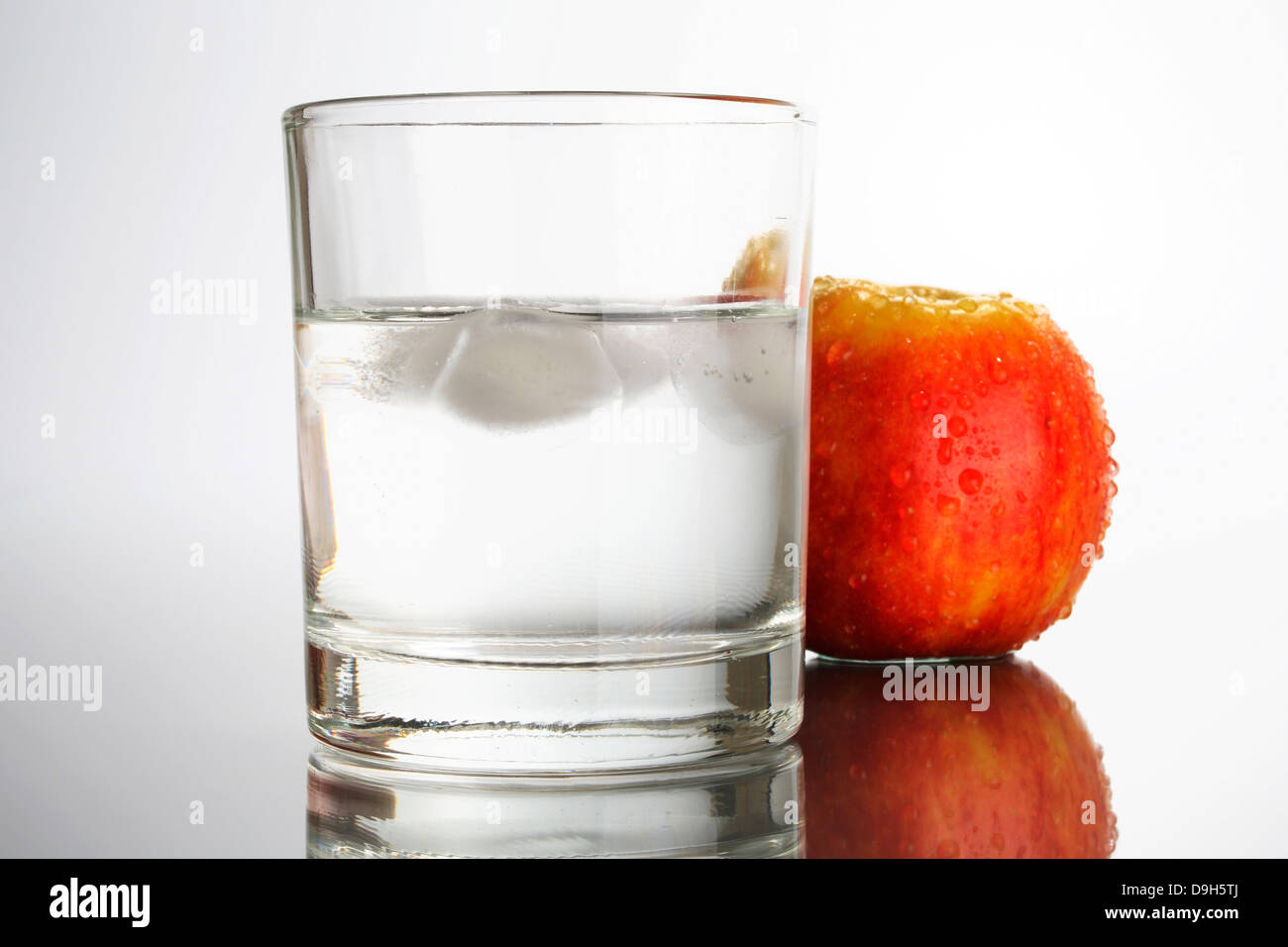 Glass of water with apple Stock Photo - Alamy