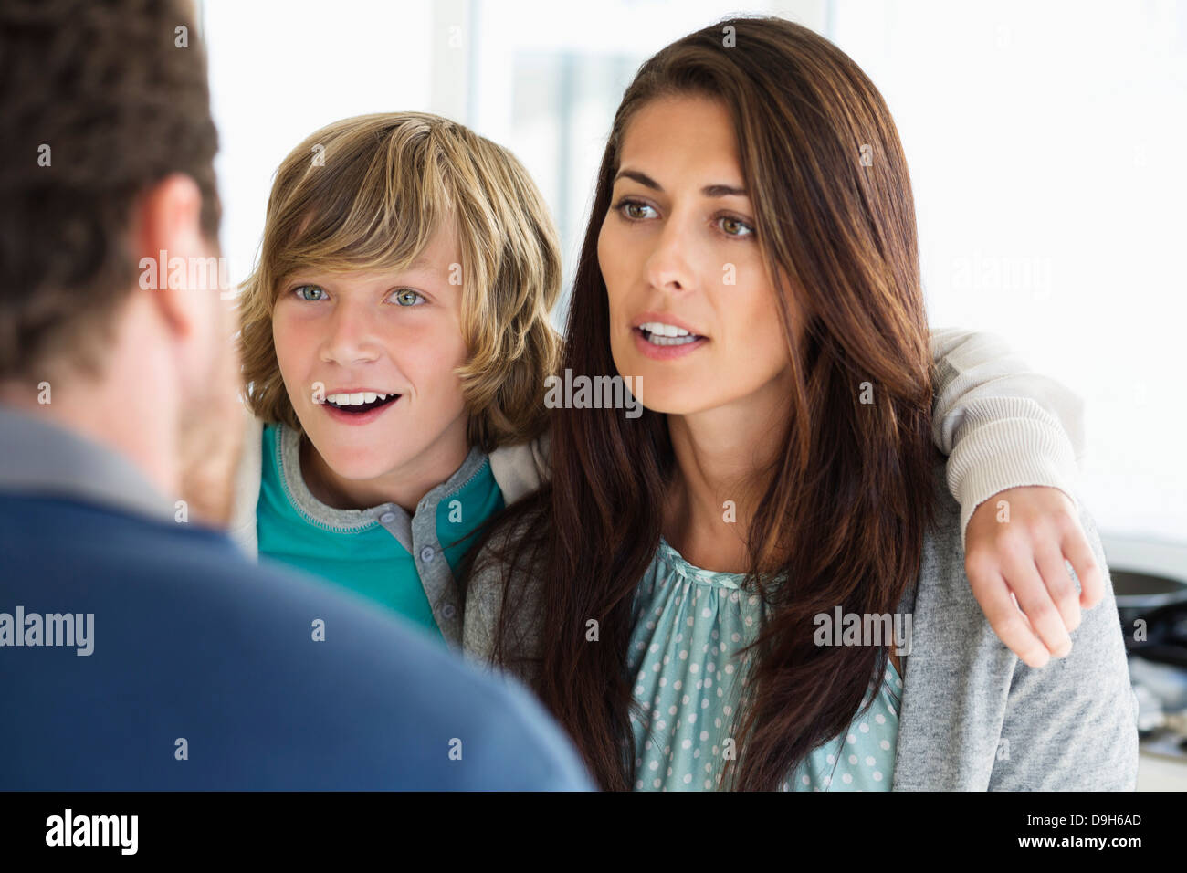 Boy with his parents discussing at home Stock Photo - Alamy