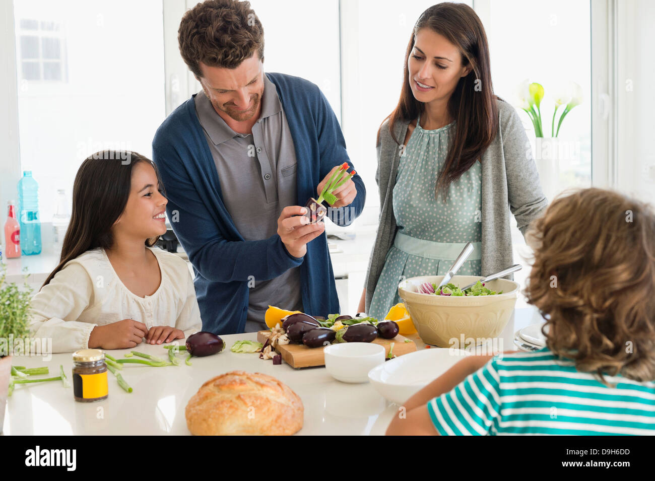 Family preparing food in the kitchen Stock Photo - Alamy