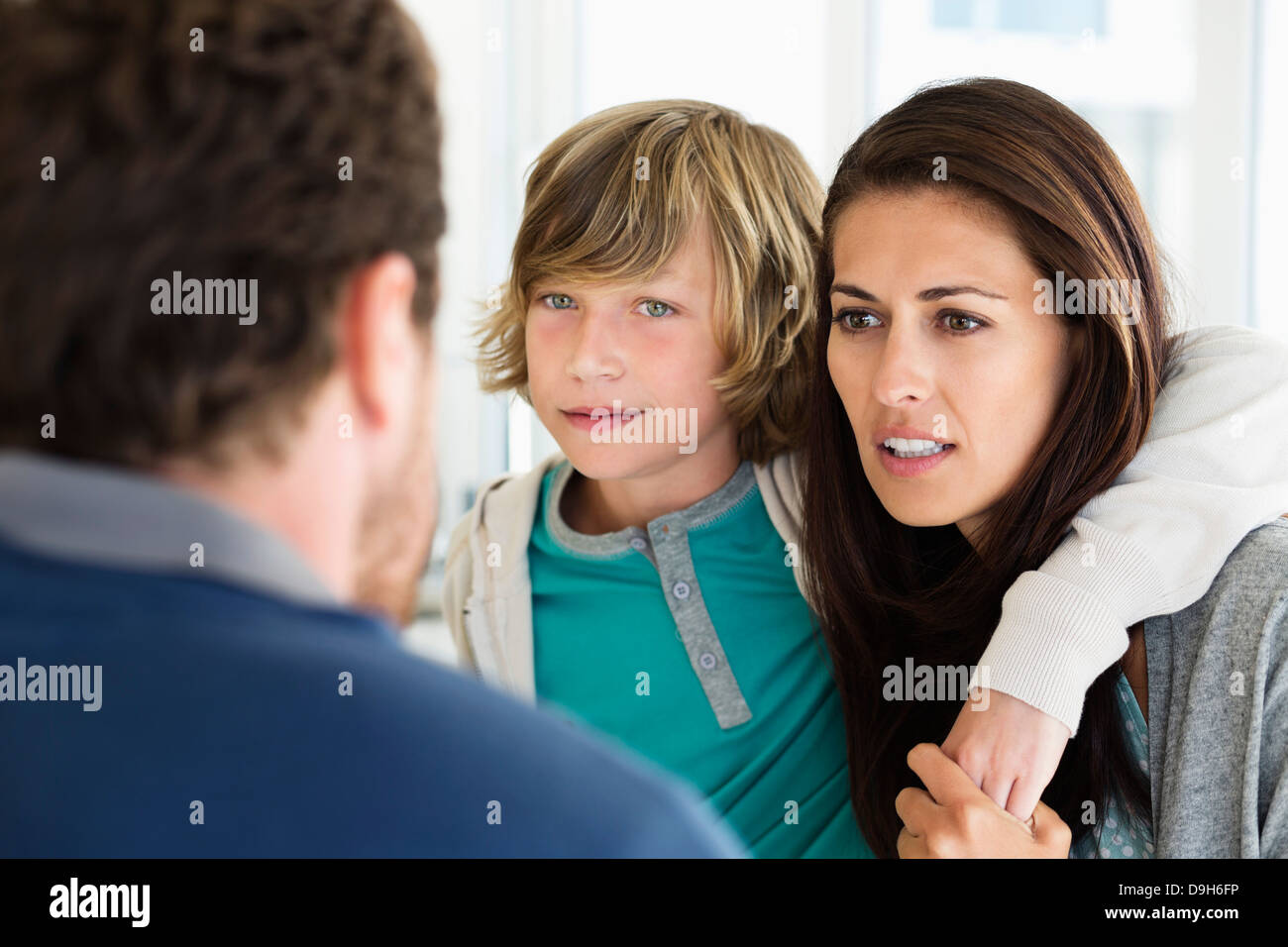 Boy with his parents discussing at home Stock Photo - Alamy