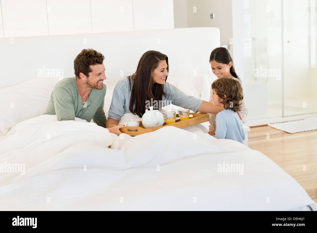 Children serving tea to their parents on the bed Stock Photo - Alamy
