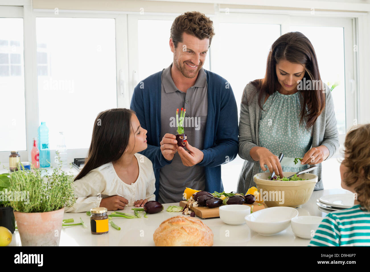 Family preparing food in the kitchen Stock Photo - Alamy