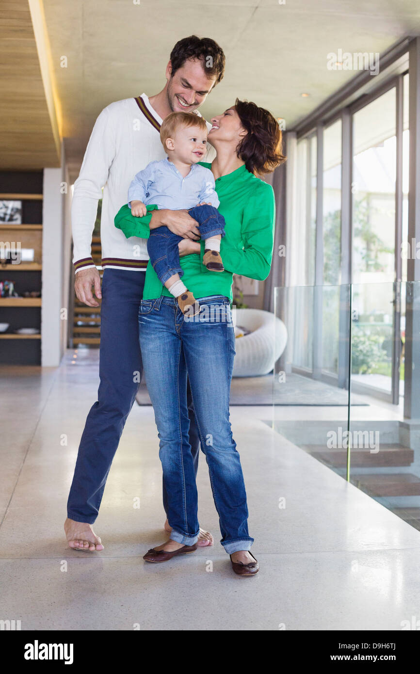 Parents smiling with their son at home Stock Photo - Alamy