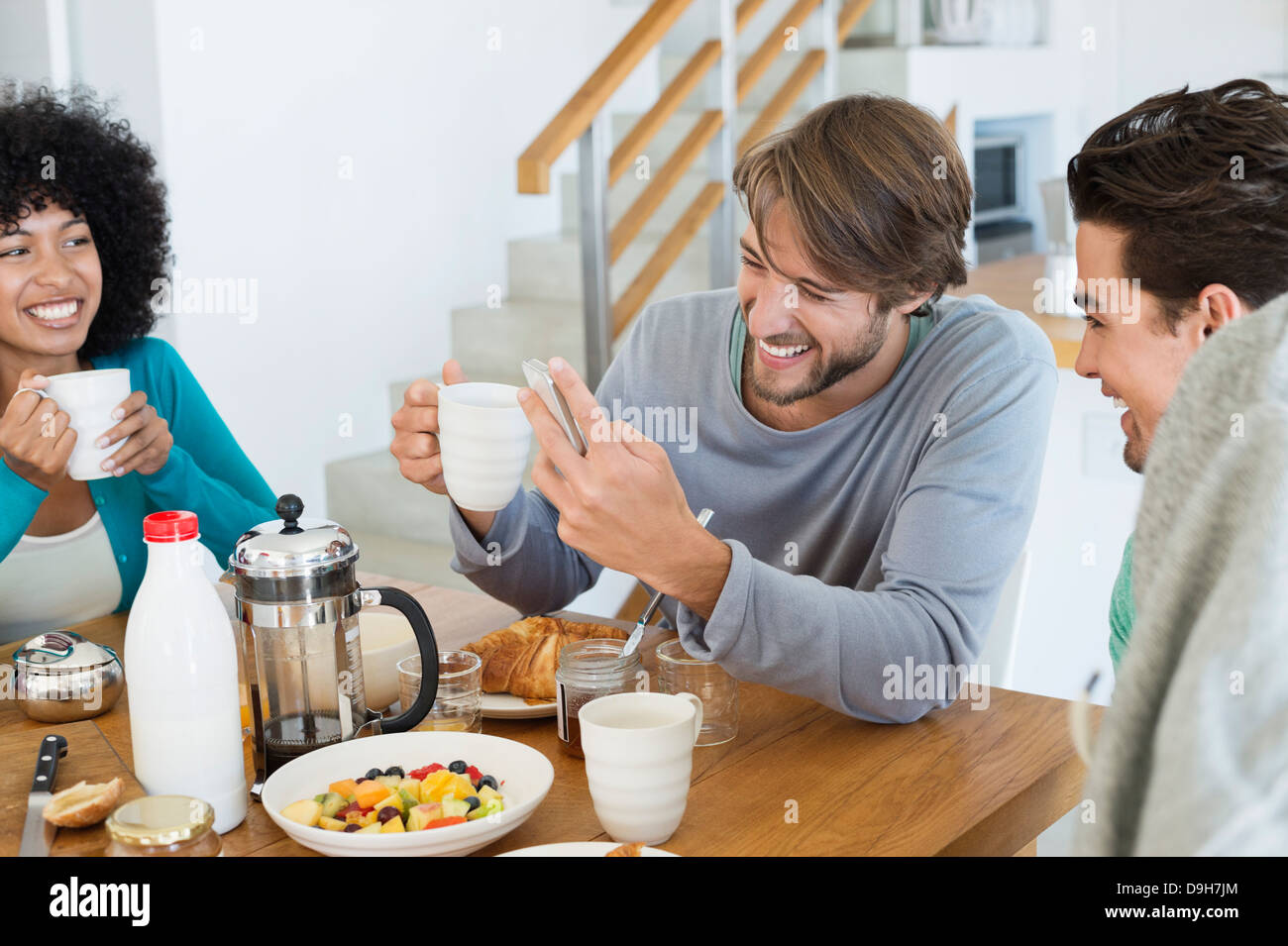 Group friends sitting table enjoying hi-res stock photography and ...