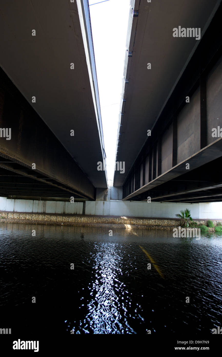 Under the bridge and a skyline reflection on the river Stock Photo - Alamy