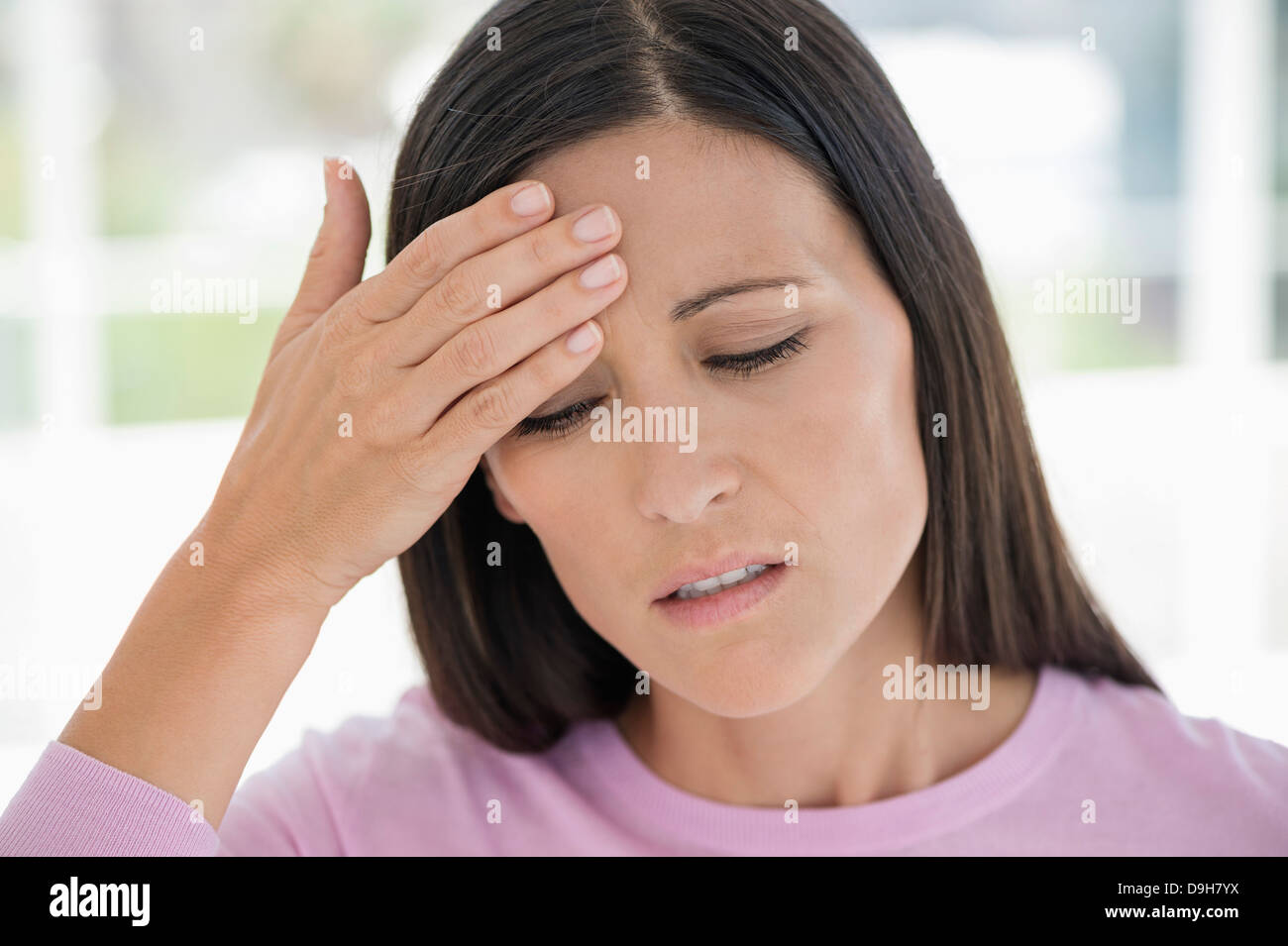 Woman suffering from a headache Stock Photo - Alamy
