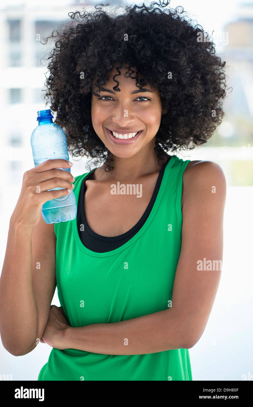 Smiling woman drinking water from a bottle Stock Photo - Alamy