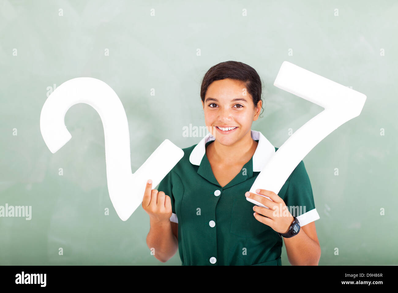 beautiful teen schoolgirl holding numbers in front of blackboard Stock ...