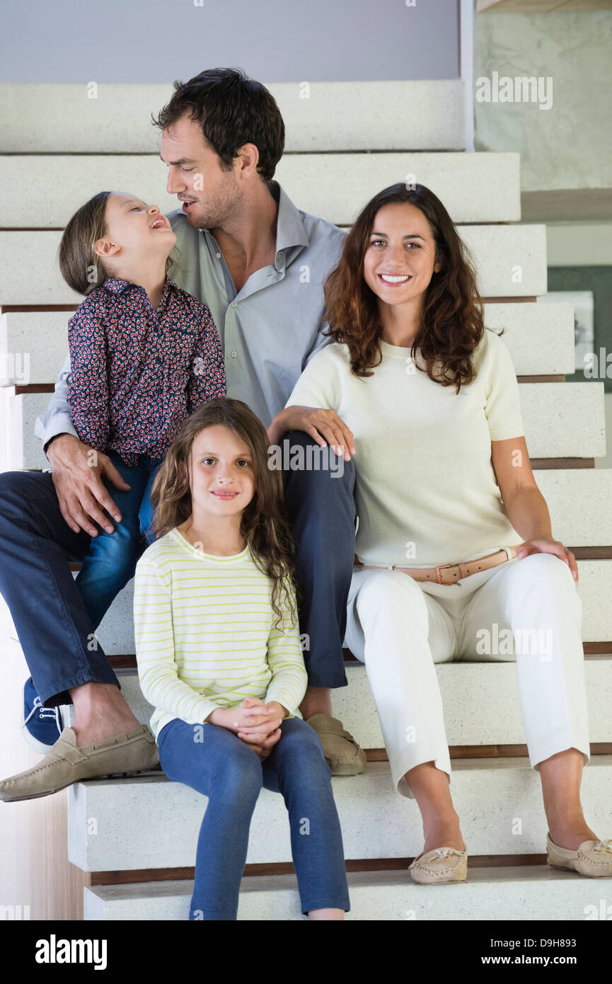 Family sitting on steps and smiling Stock Photo - Alamy