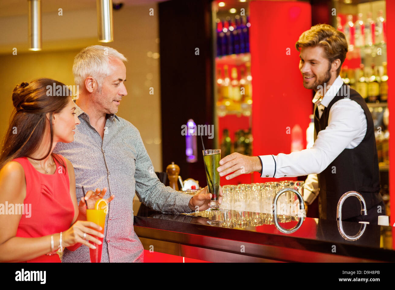 Bartender serving woman cocktail bar hi-res stock photography and ...