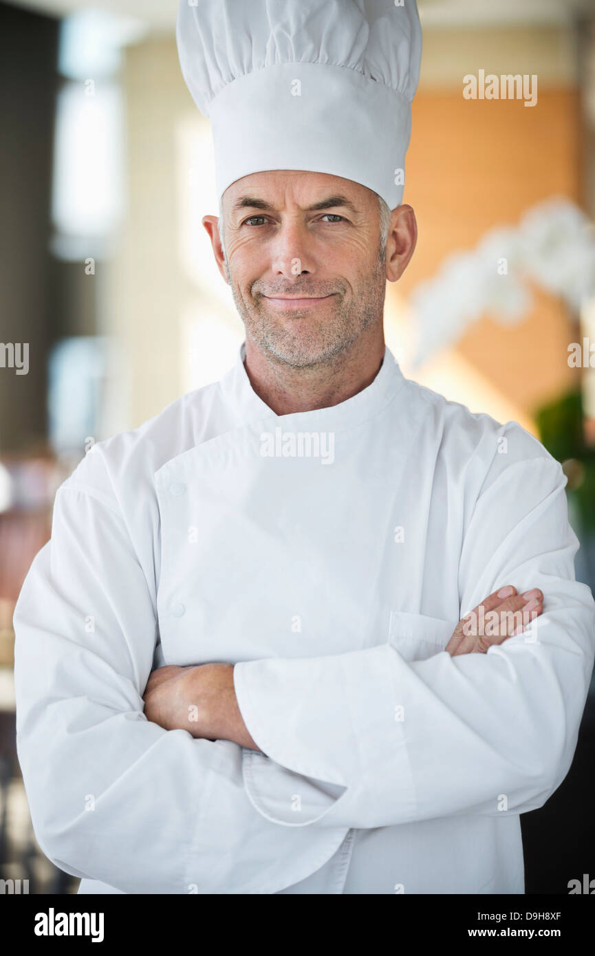 Portrait of a chef smiling with arms crossed Stock Photo - Alamy