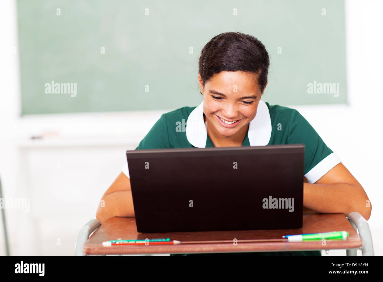 female high school student using laptop in classroom Stock Photo - Alamy
