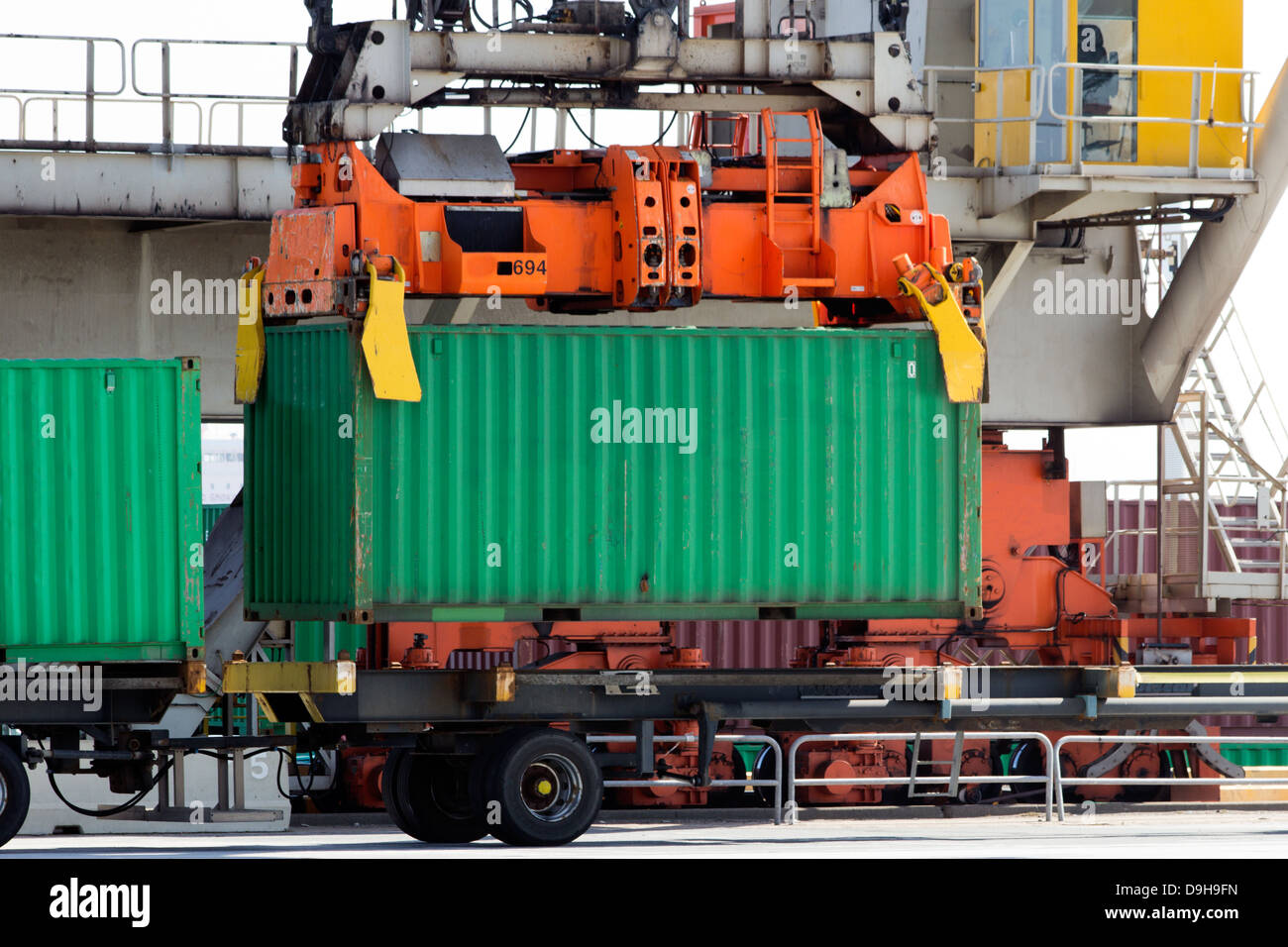 Harbor crane lifting a sea container Stock Photo - Alamy