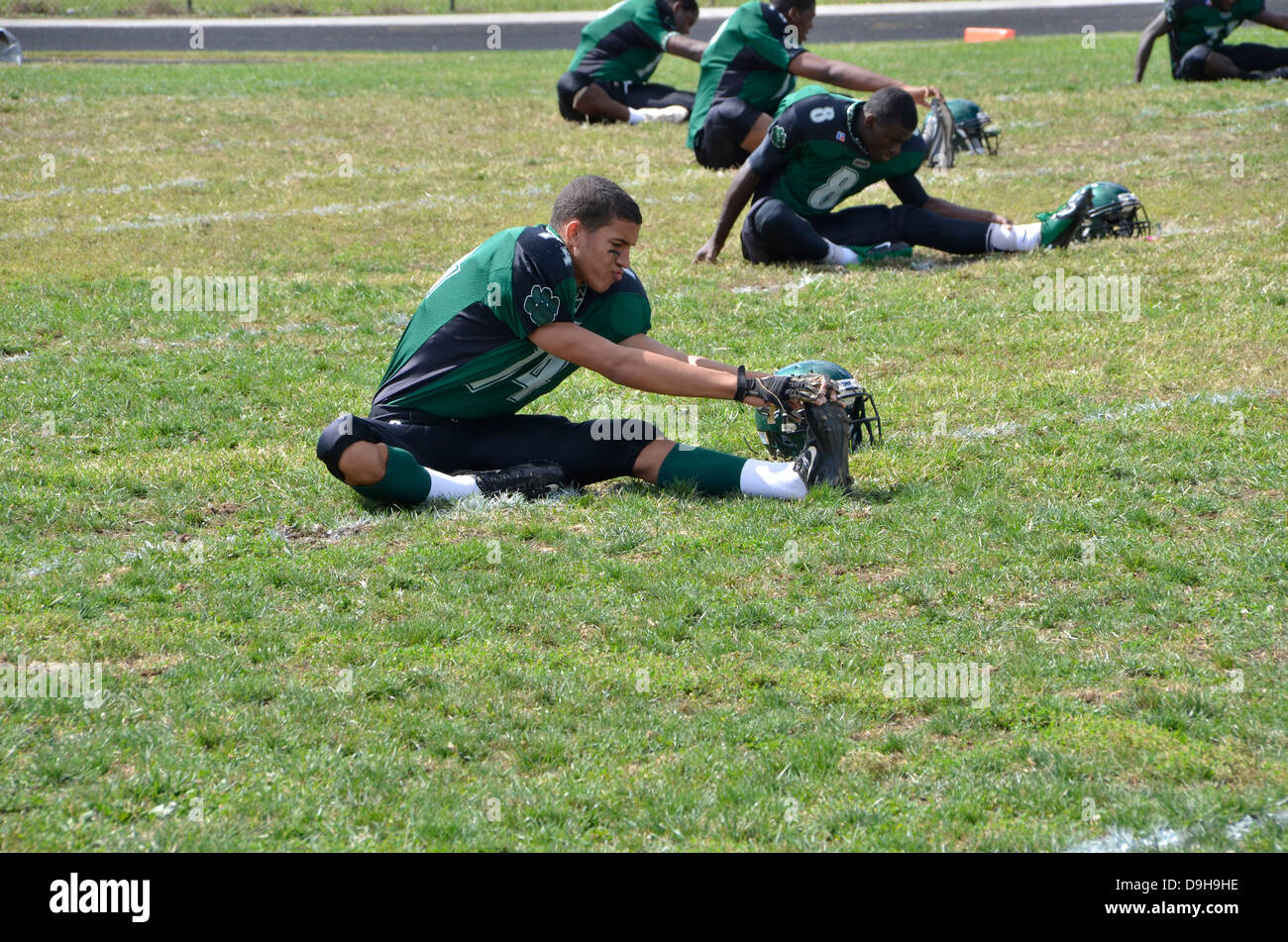 Football player stretching and exercising before the game Stock Photo ...