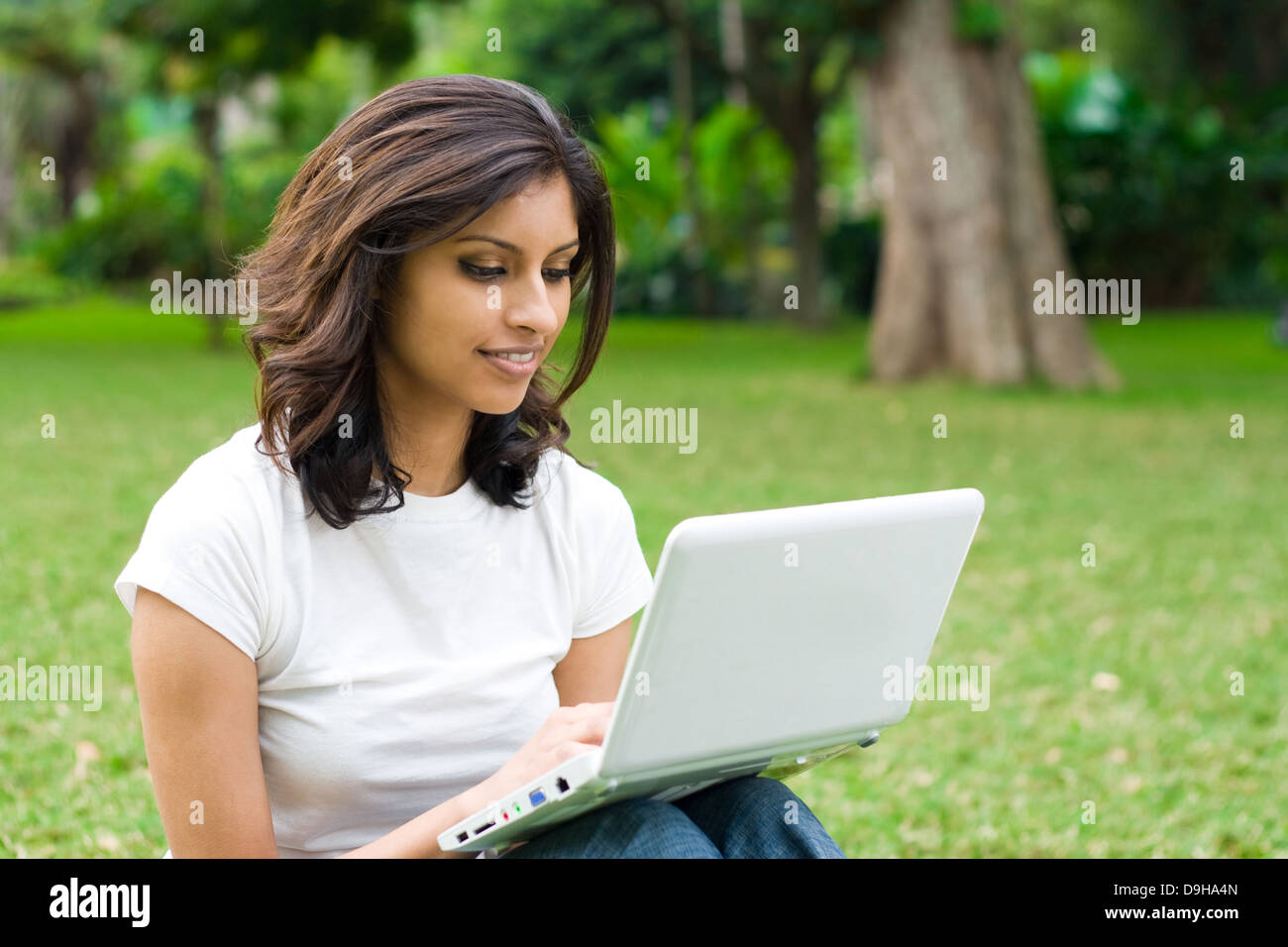 young Indian woman using laptop outdoors Stock Photo - Alamy