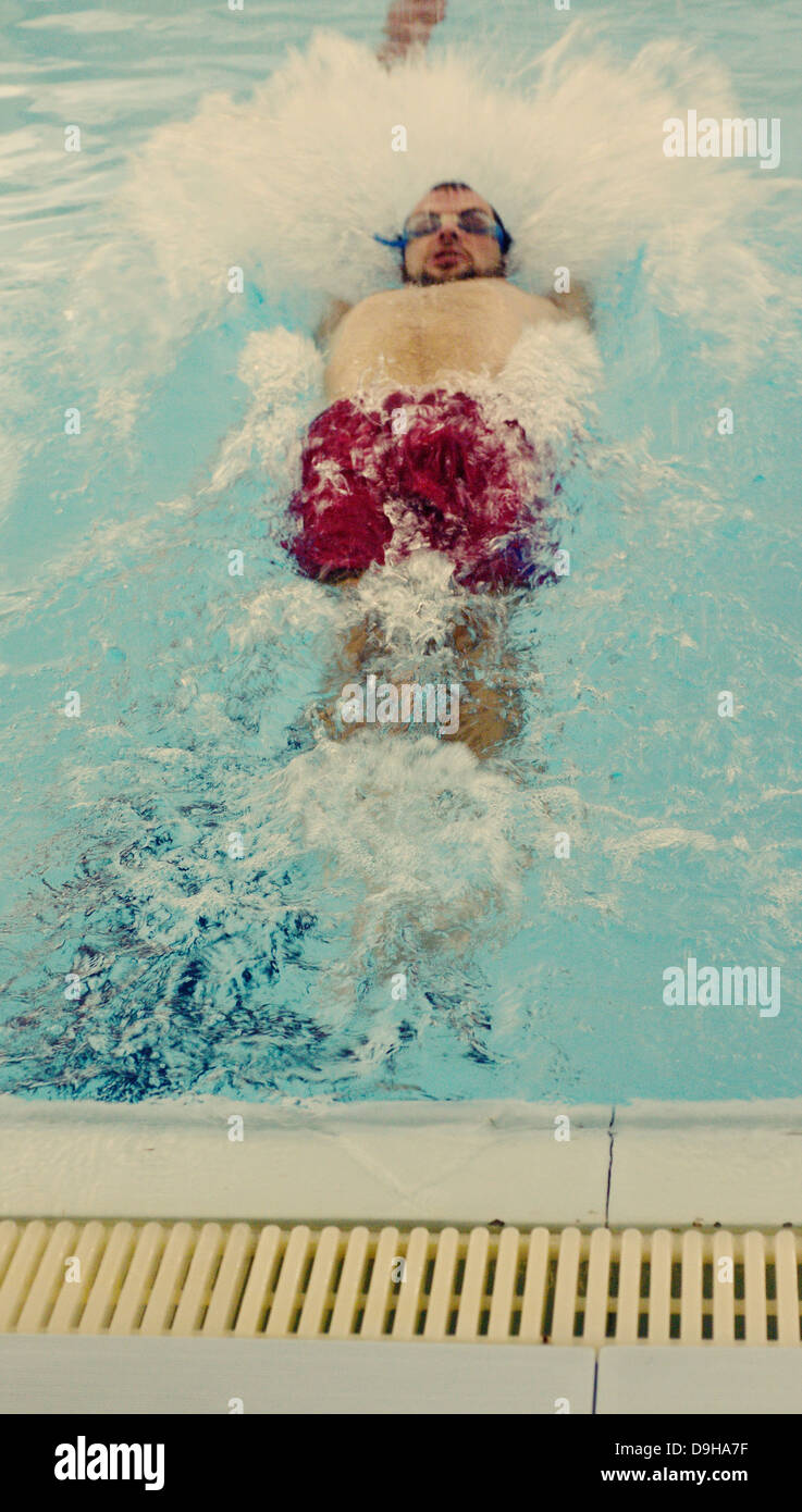 Man diving into water for a backstroke race Stock Photo - Alamy
