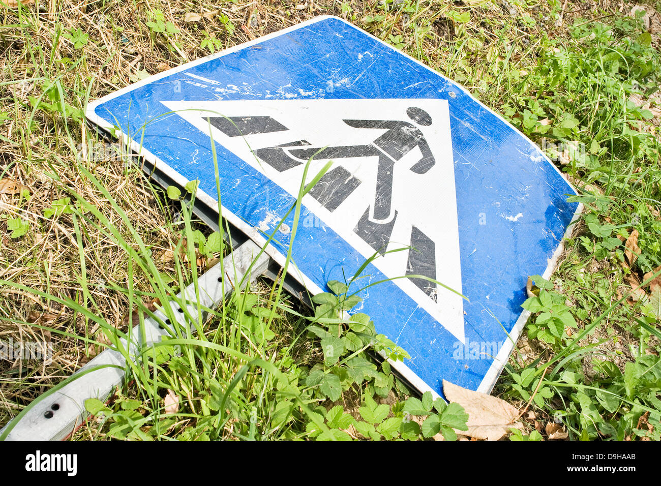 On the ground recumbent sign on a crosswalk, A pedestrian crossing sign ...